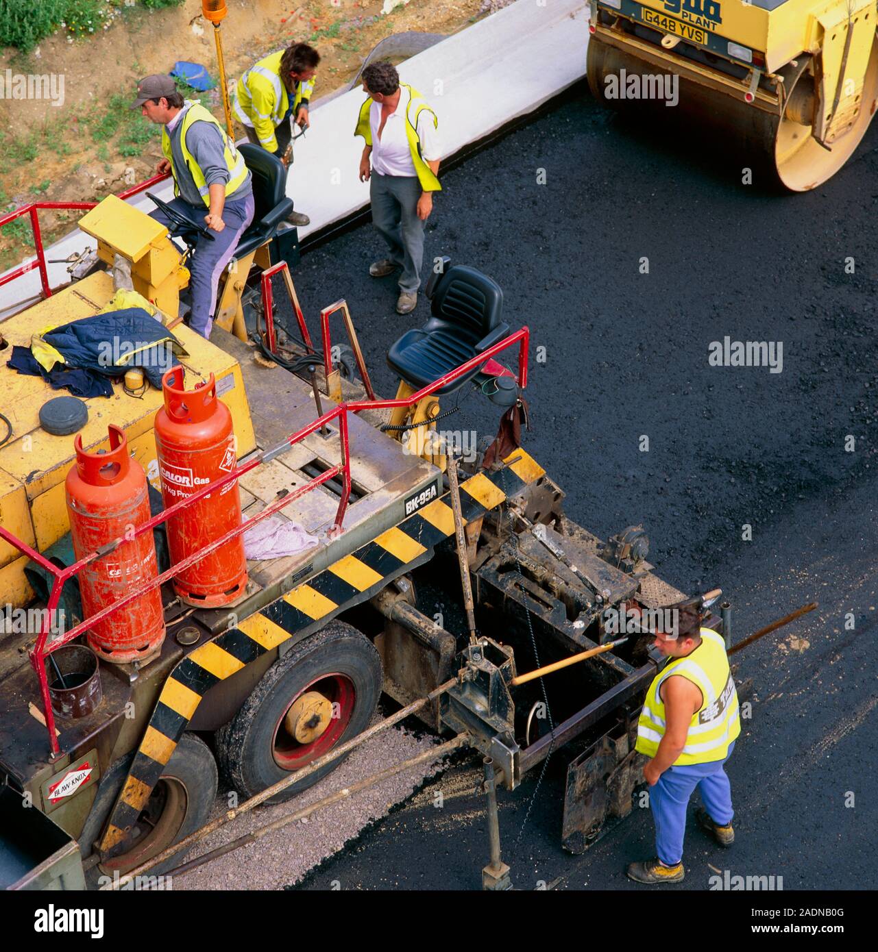 Road construction. Laying of the second course of a road. Asphalt ...