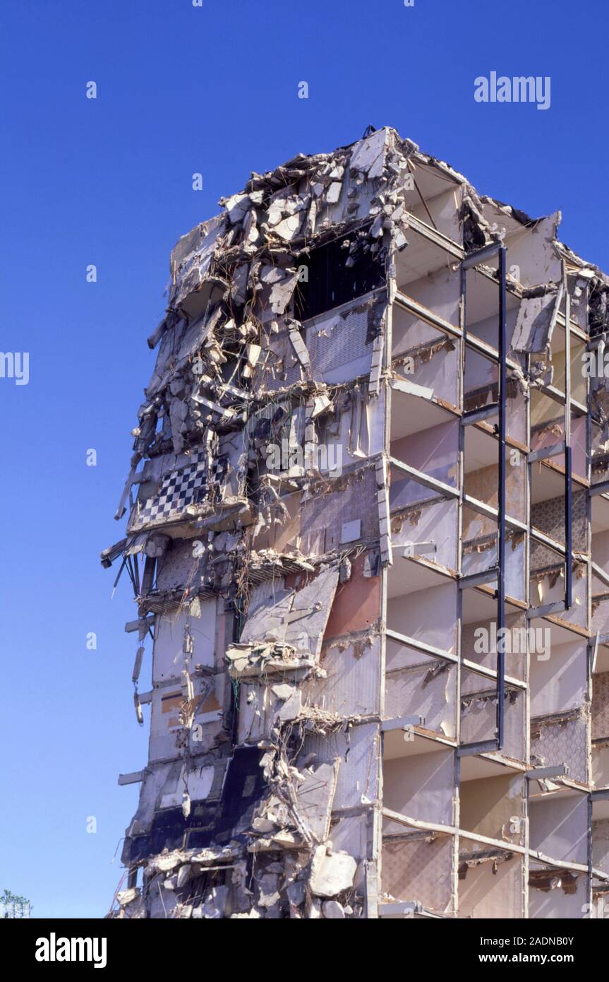Tower block demolition. Residential tower block during demolition ...