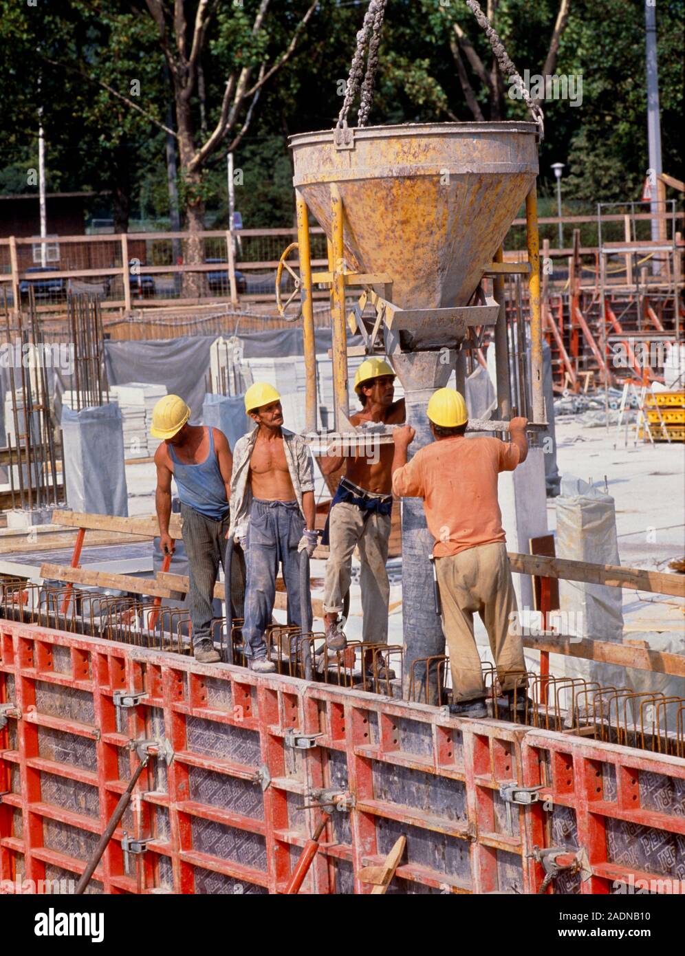 Reinforced concrete. Workmen constructing a reinforced concrete wall by ...