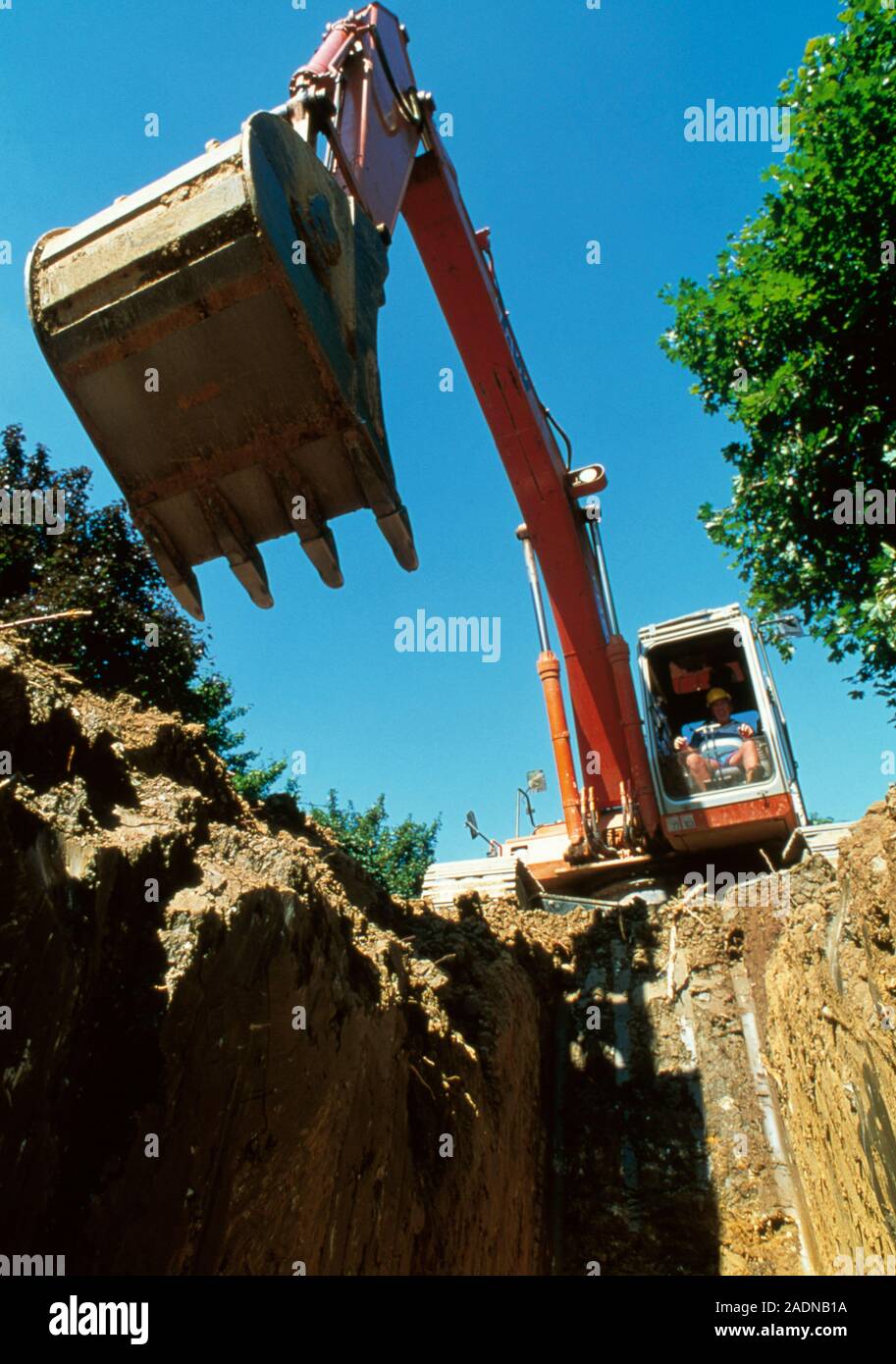 Mechanical digger. View of a mechanical digger excavating a drainage ...