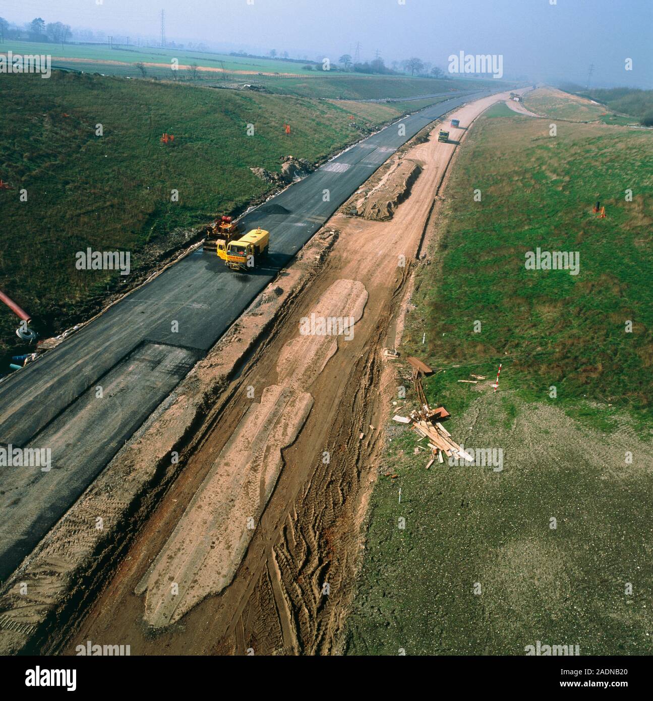 Road construction displaying the stages in laying a concrete road. The ...