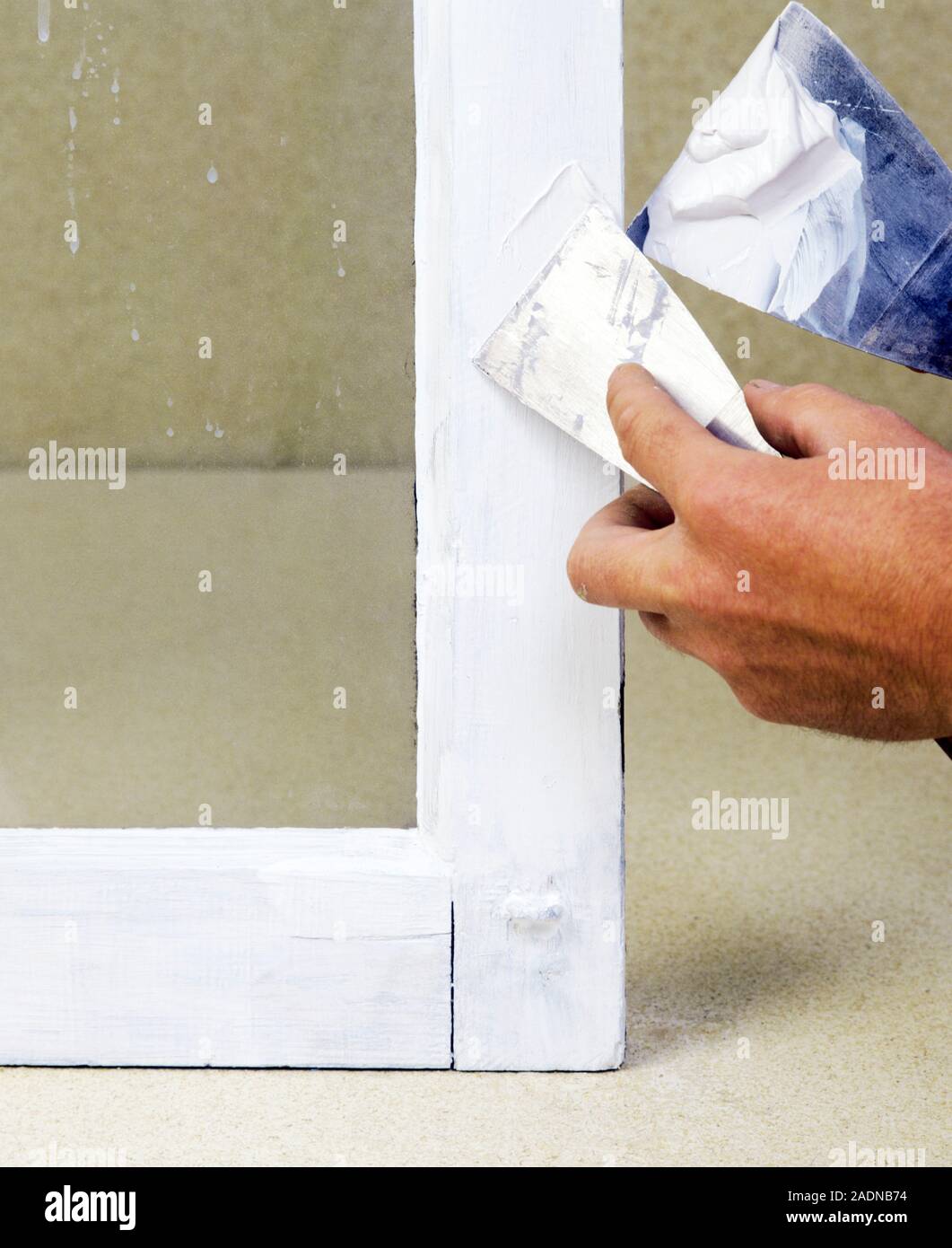 MODEL RELEASED. Window frame restoration. Image 7 of 8. Smoothing out ...