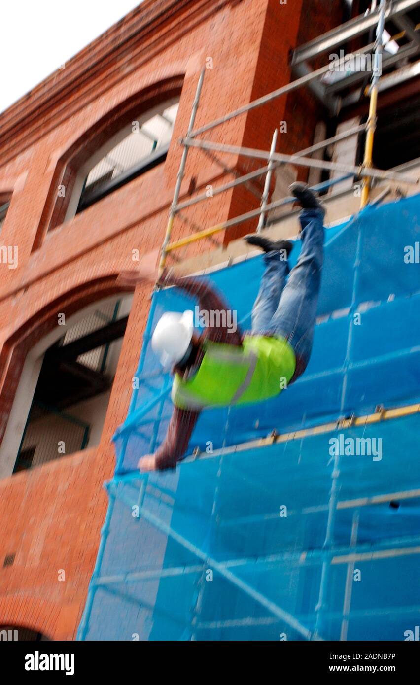 MODEL RELEASED. Building site accident. Construction worker falling ...