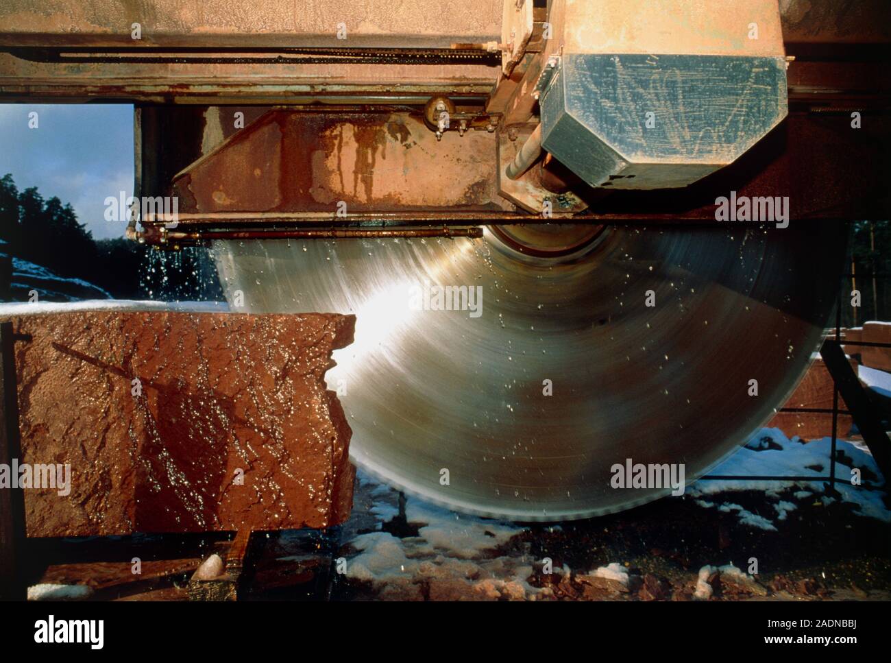 Cutting sandstone. Circular saw being used to cut a block of sandstone ...