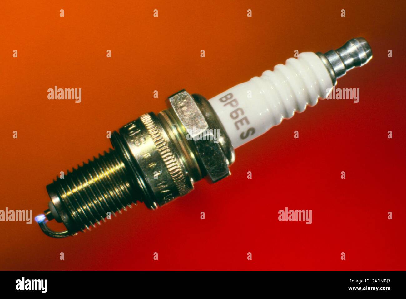A car spark plug firing. Spark plugs are used in petrol engines to ...