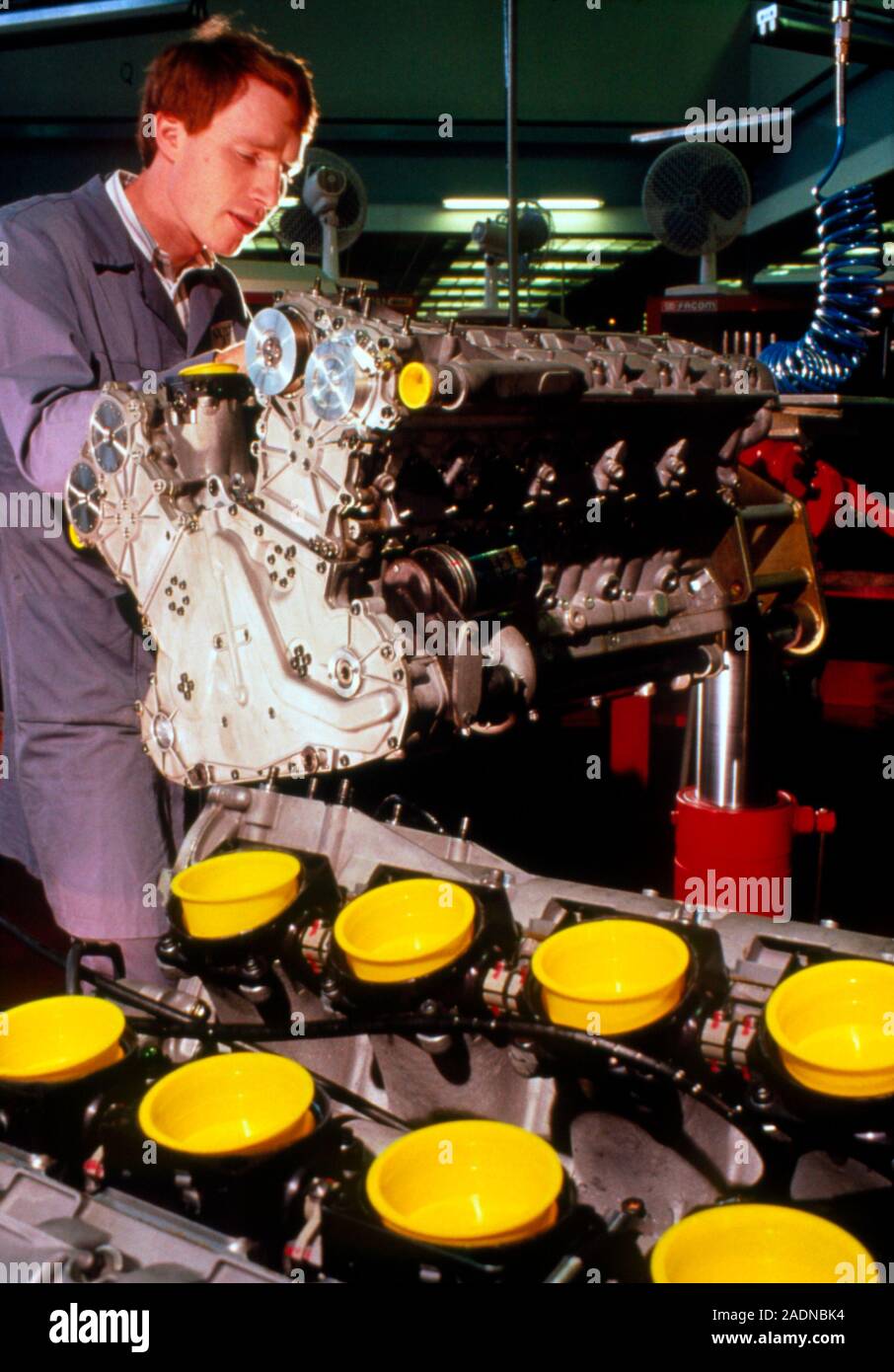 Formula One racing engine. A technician performing final assembly ...