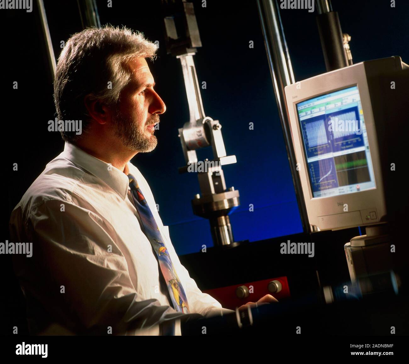 Piston fatigue test. Male engineer using a computer during a fatigue ...