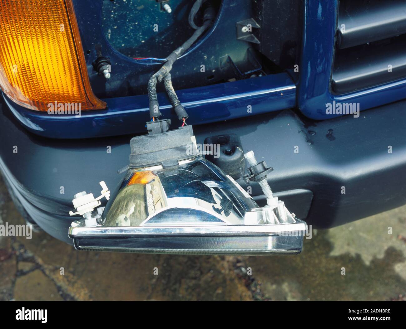 Car headlamp removed from the chassis to reveal its wiring Stock Photo ...