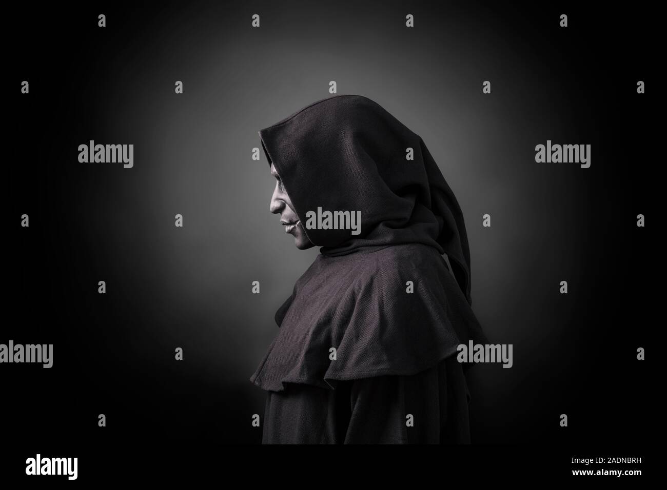 Scary figure in hooded cloak with mask Stock Photo - Alamy
