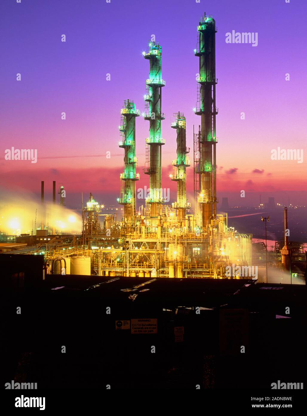 Chemical plant at dusk. View of the reactor towers of a chemical ...