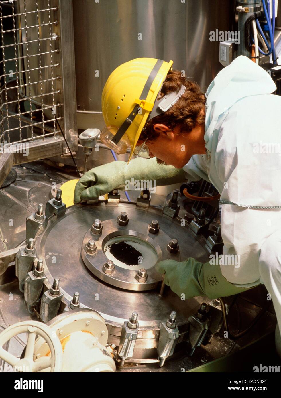 Chemical process inspection. Worker viewing a chemical production ...
