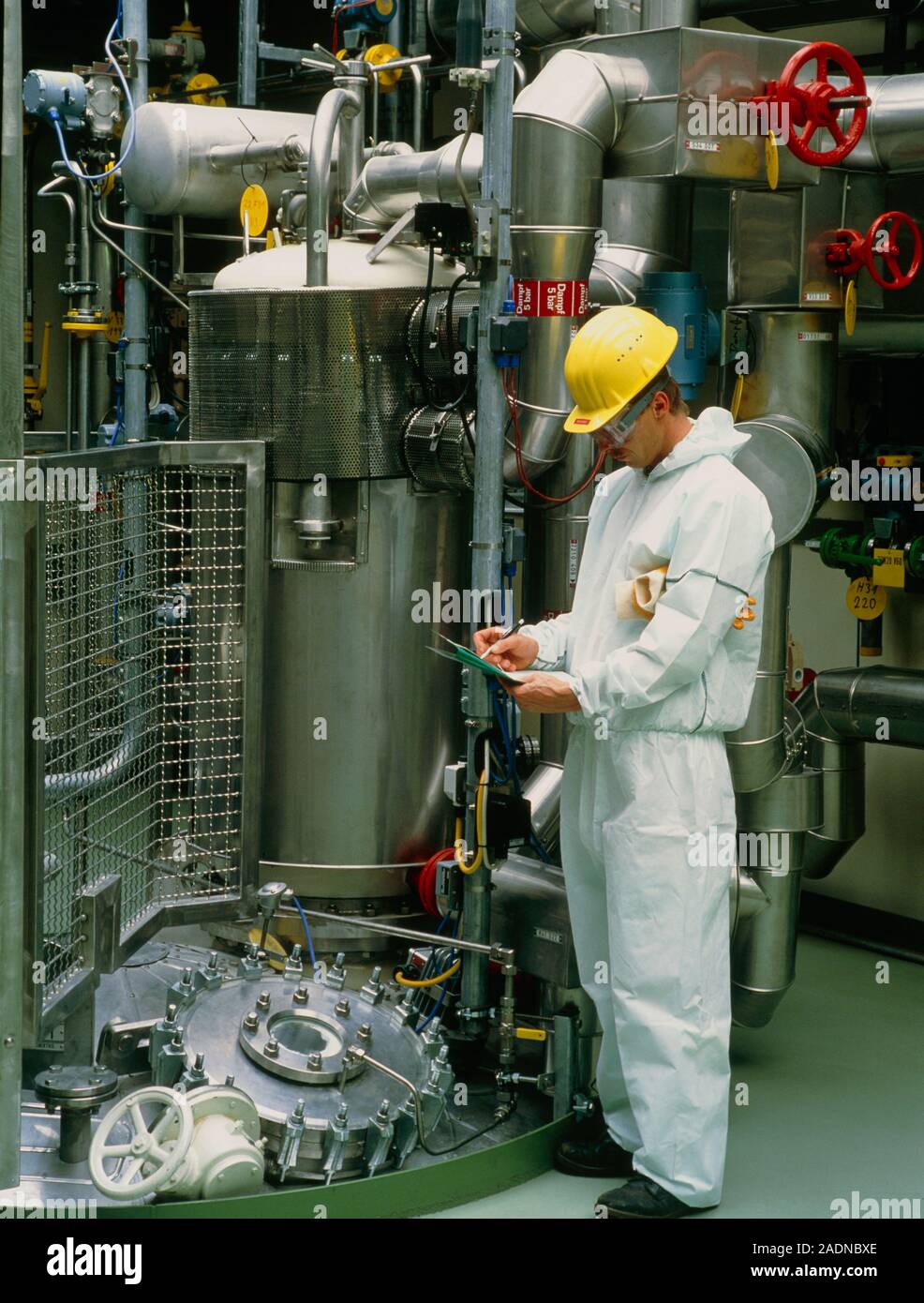 Chemical worker. Worker in the chemical industry reading instructions ...