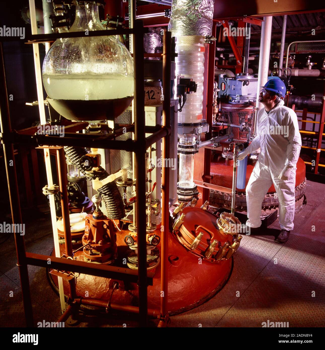Chemical factory. Industrial chemist monitoring a reaction in a factory ...