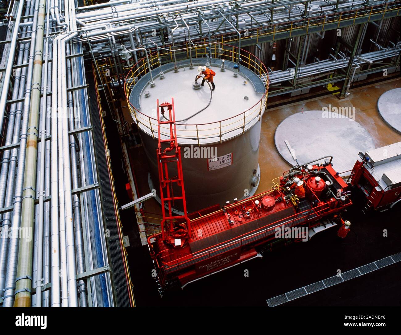 Fire brigade at a chemical plant dealing with an emergency. Chemical ...