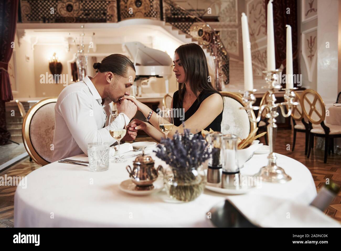 Man kisses girl dinner table hi-res stock photography and images - Alamy