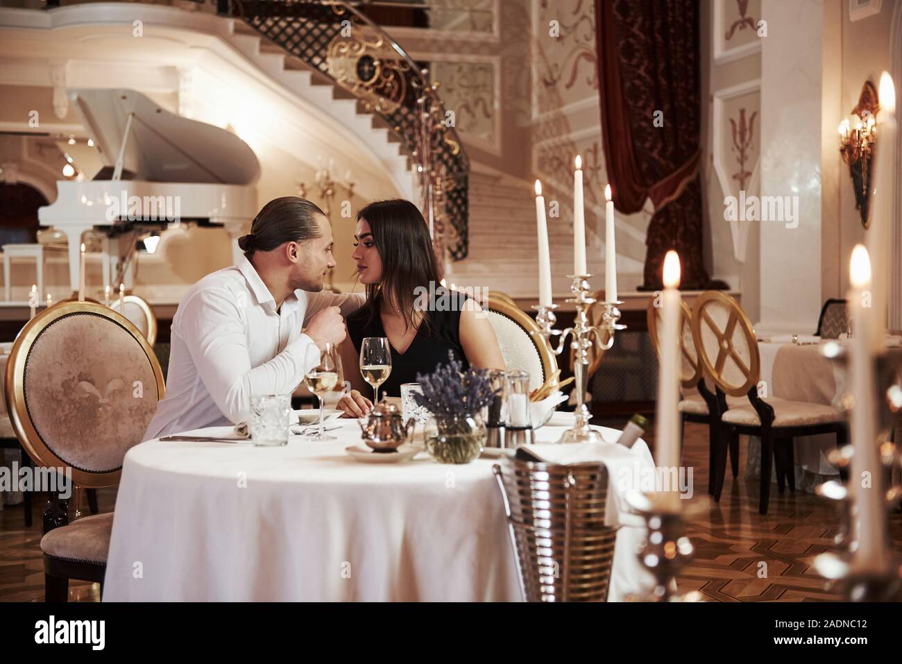 Classical scene with many candles and lovers. Beautiful couple have ...