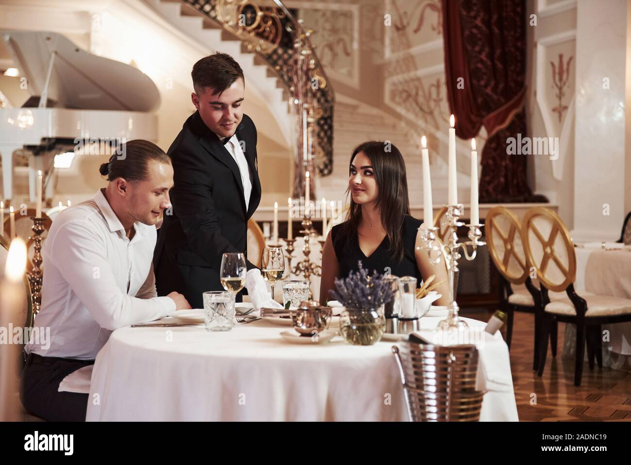 Professional service. Beautiful couple have romantic dinner in luxury ...