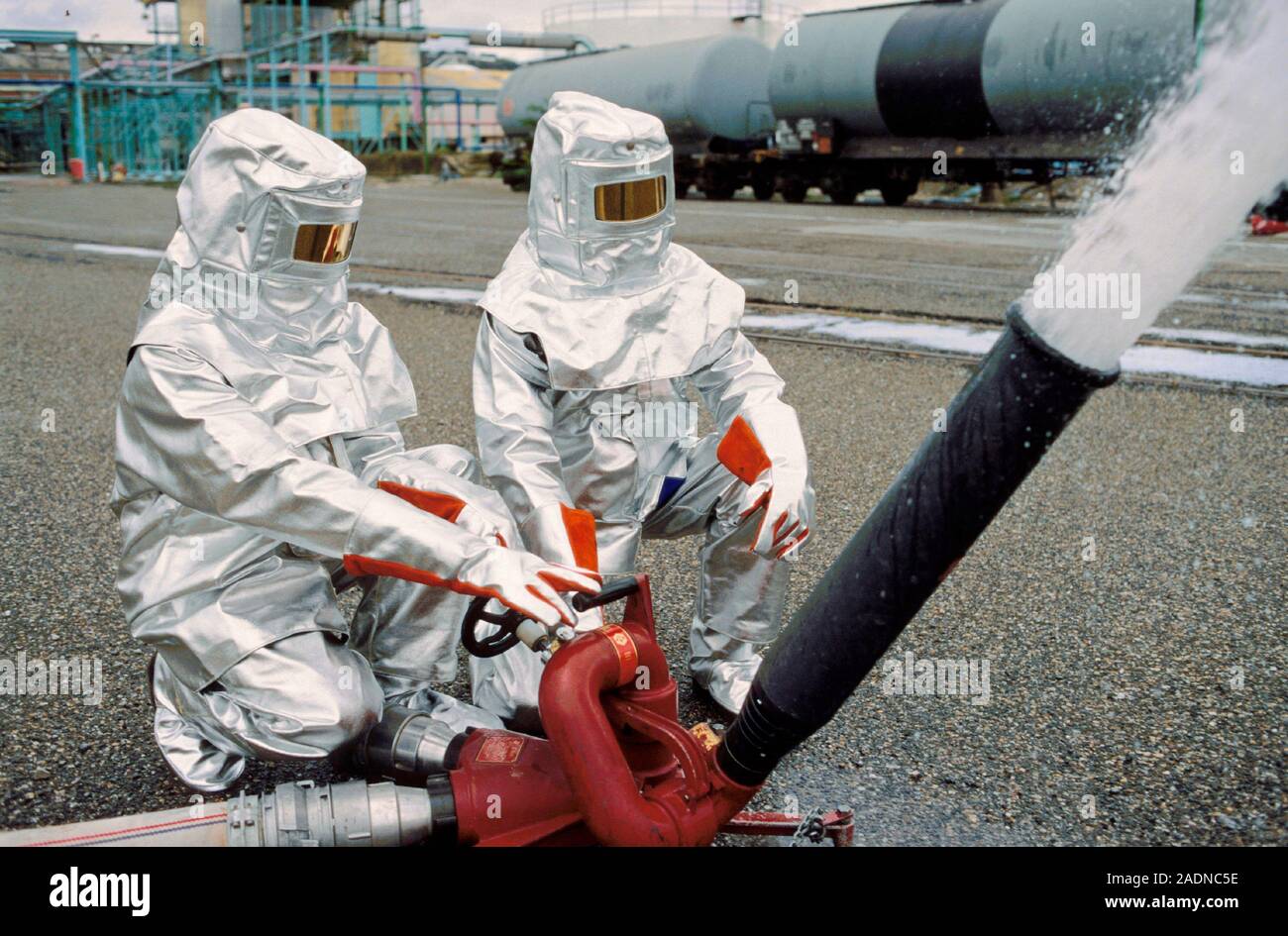 Industrial disaster firefighting. Firefighters in protective suits ...