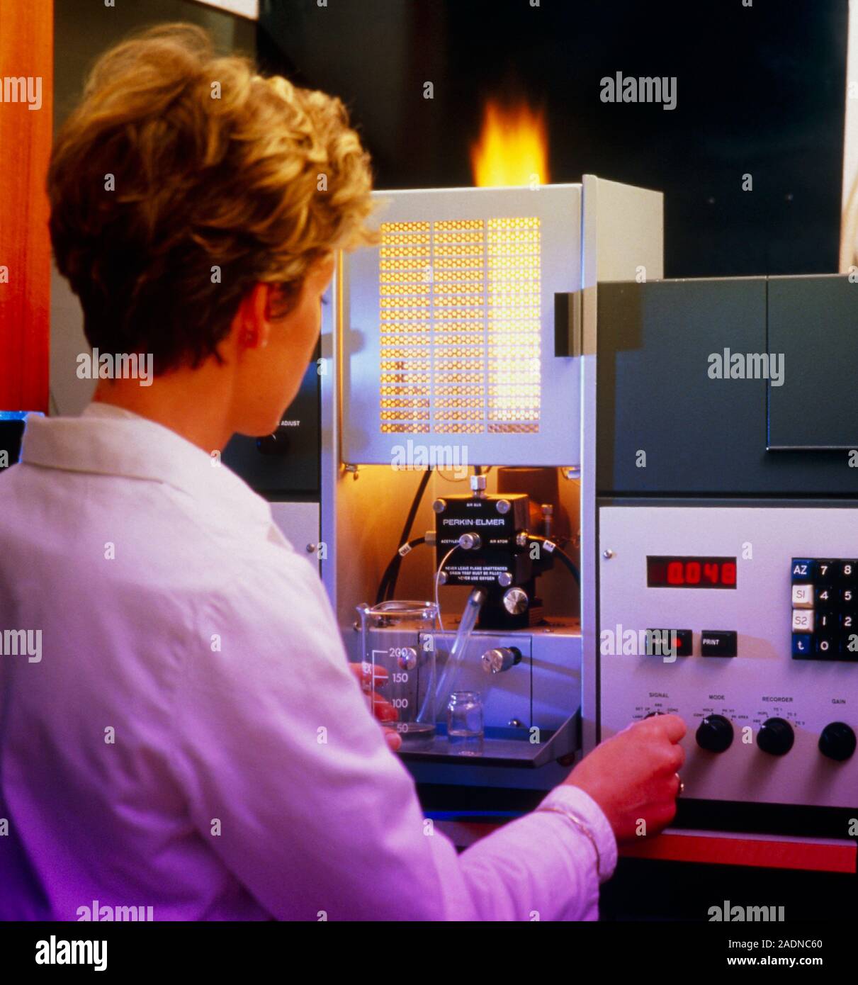 Analytical chemist using an atomic absorption (AA) spectrometer to ...