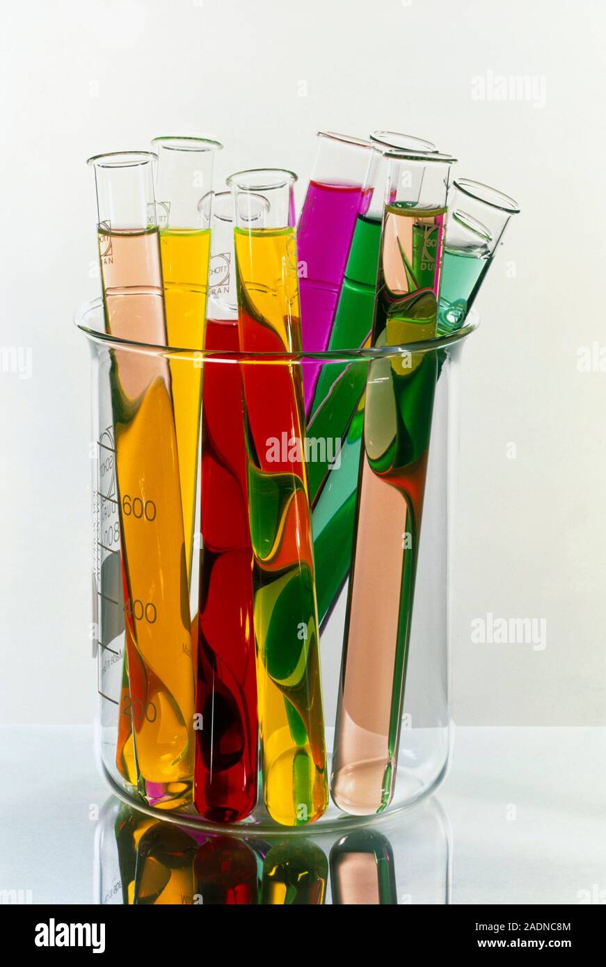 Test tube. Test tubes in a beaker on a reflective surface. The tubes ...
