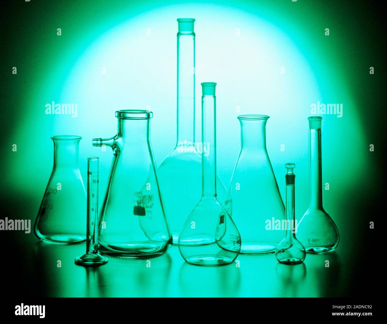 Chemical flasks. Assortment of empty laboratory flasks and a measuring ...