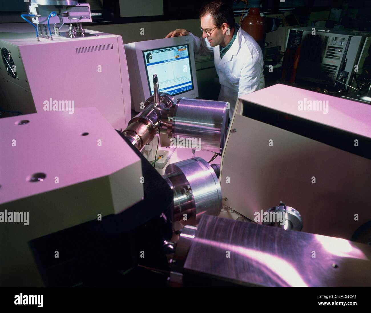 Isotope ratio mass spectrometry. Technician observes the visual display ...