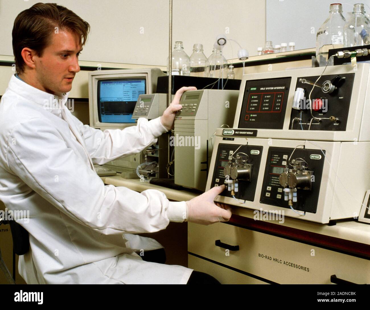 High-performance liquid chromatography. Male technician operating High ...
