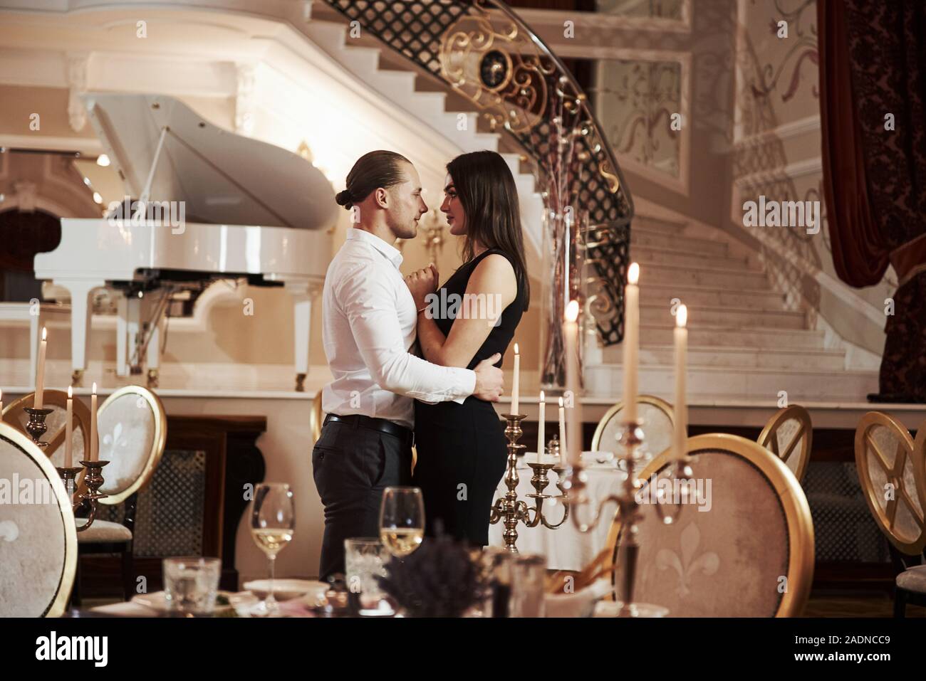 Dance time. Beautiful couple have romantic dinner in luxury restaurant ...