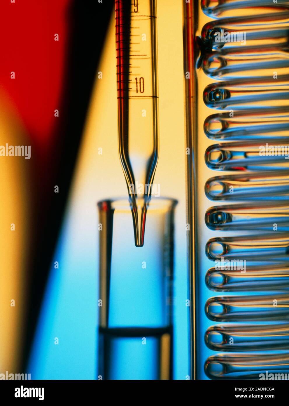 Laboratory glassware. View of a pipette being held above a test tube ...