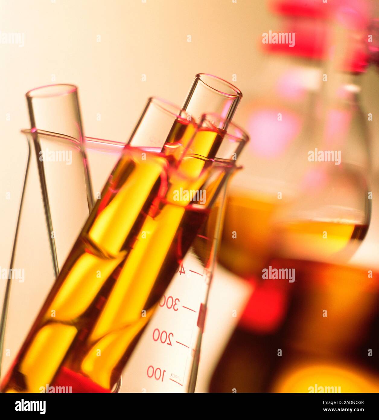Laboratory glassware containing an orange liquid Stock Photo - Alamy