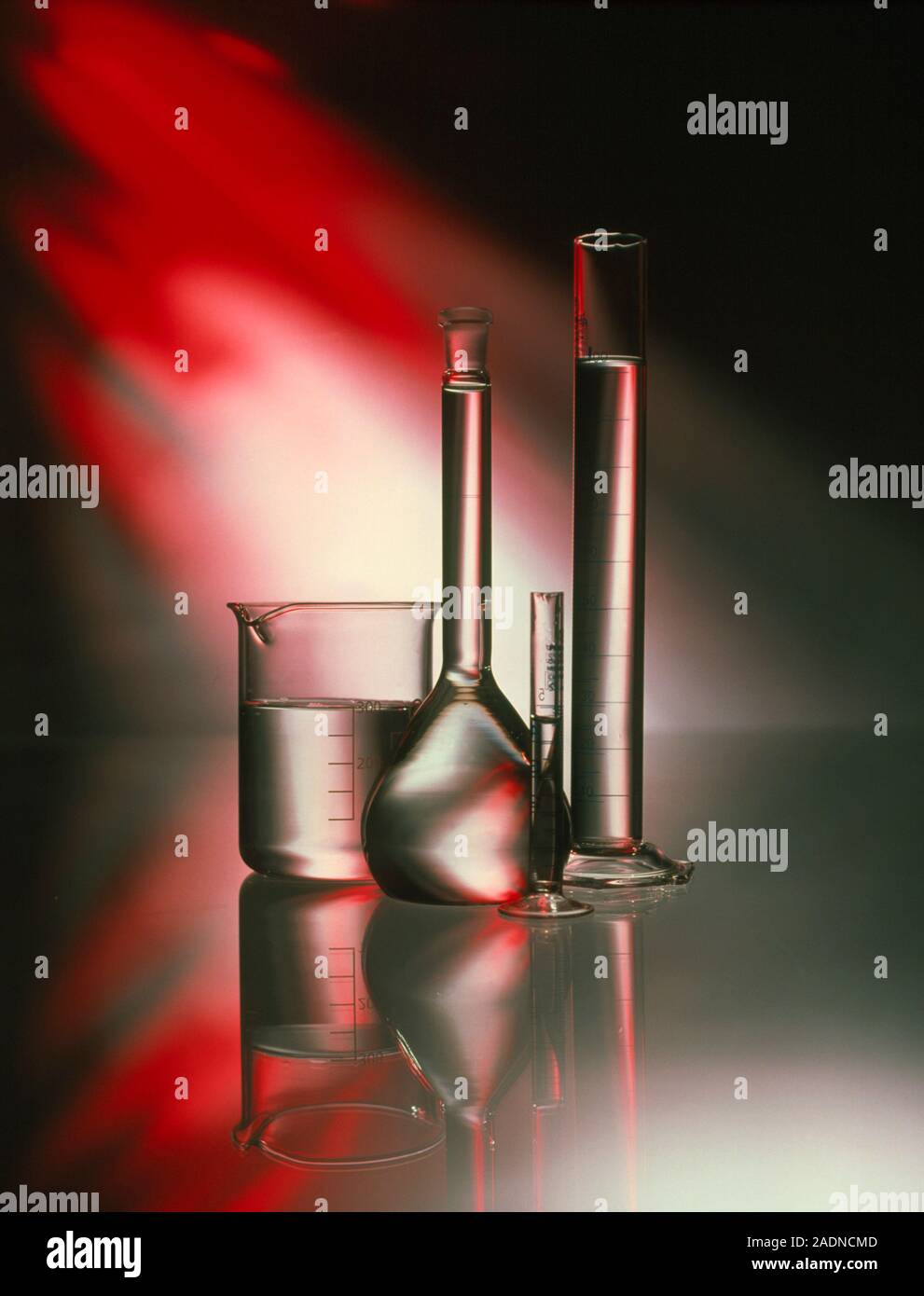 Laboratory glassware. Selection of glass containers holding a clear ...