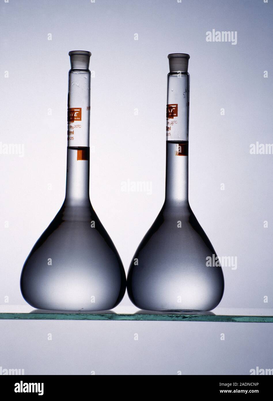 Laboratory glassware. Two volumetric flasks holding clear liquids Stock ...