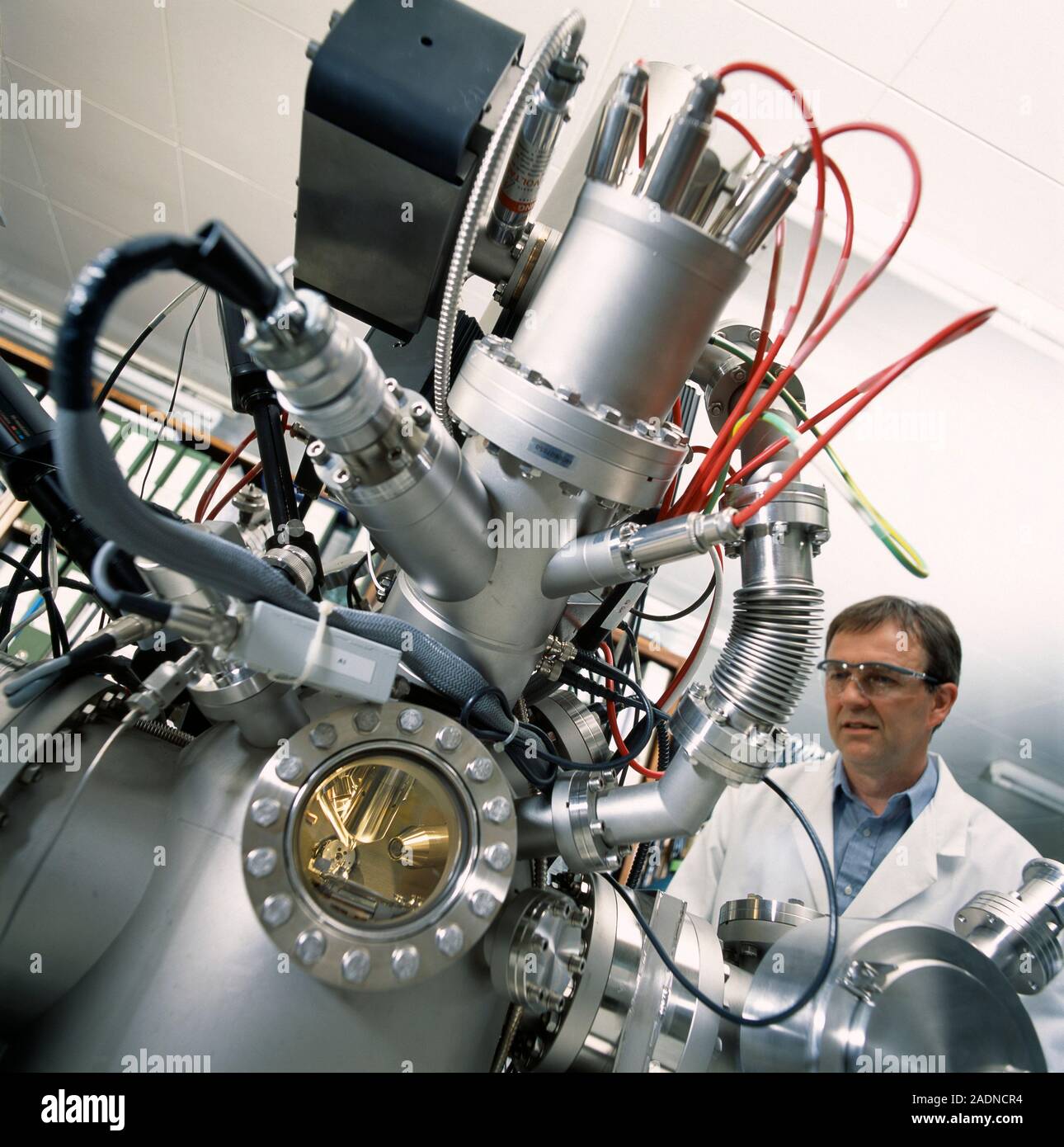 Mass spectrometer. Researcher observing a time of flight secondary ion ...