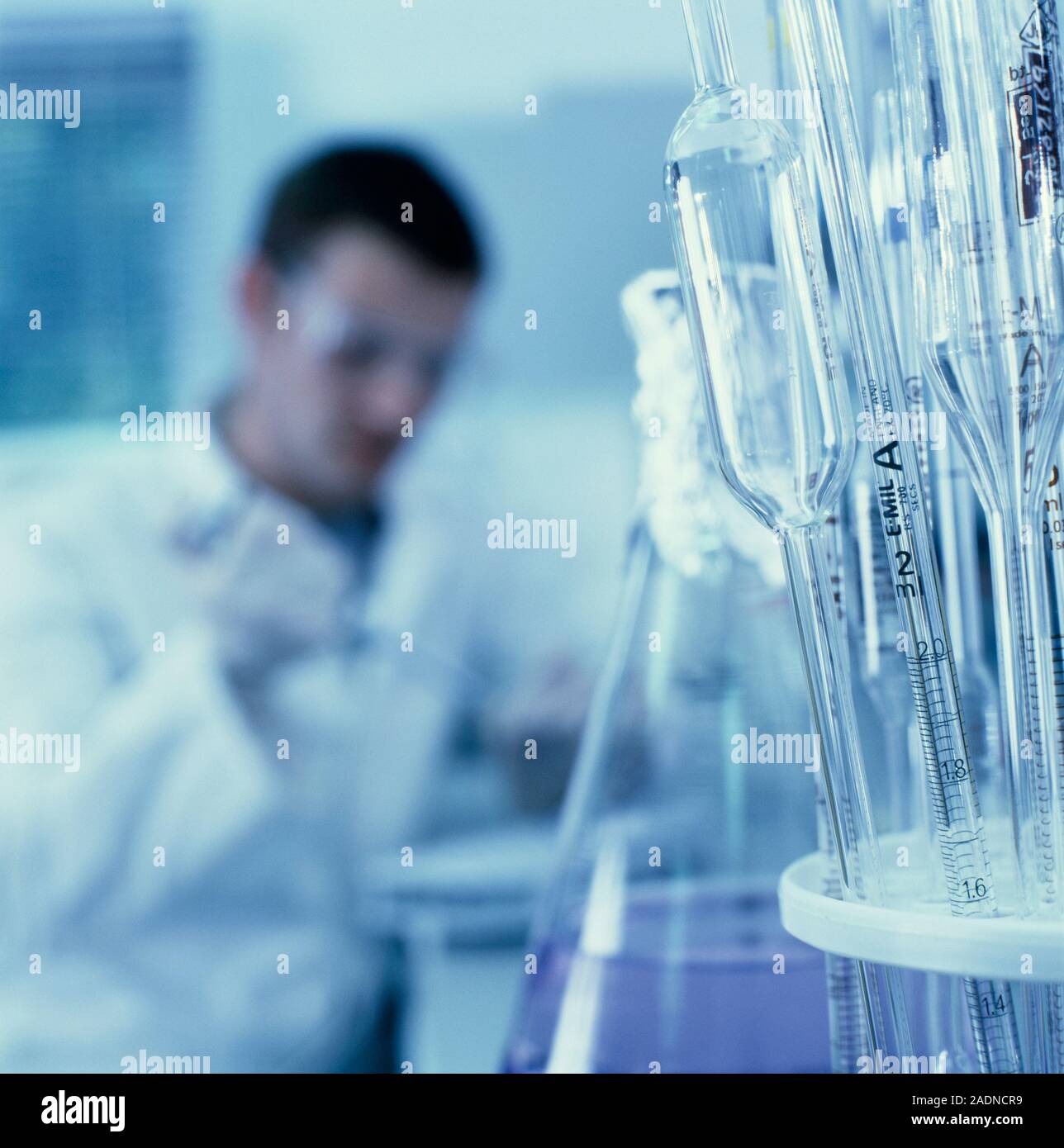 Laboratory equipment. Volumetric pipettes with a laboratory technician ...