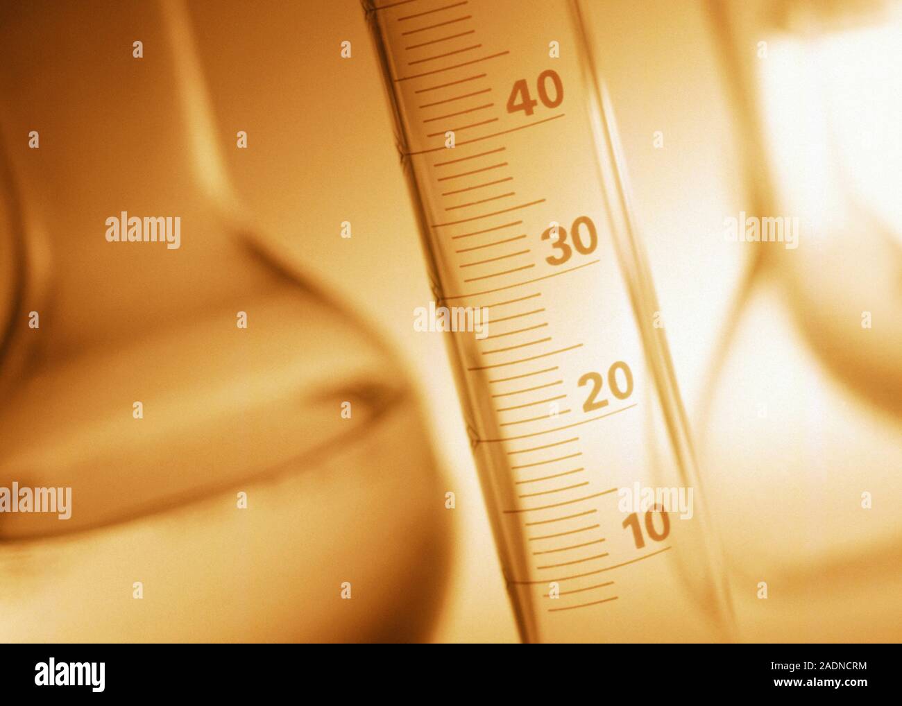Laboratory glassware. Round-bottomed flasks and a measuring cylinder ...