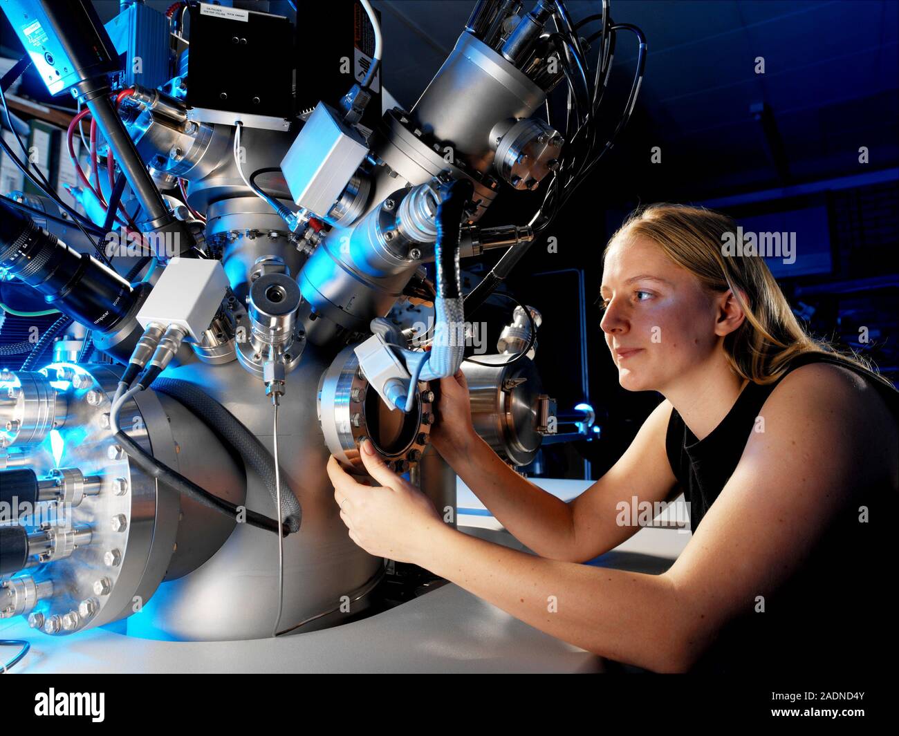 Mass spectrometry. Physicist holding a mass spectrometer used in G-SIMS ...