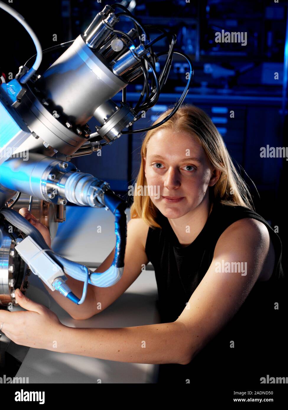 Mass spectrometry. Physicist holding a mass spectrometer used in G-SIMS ...