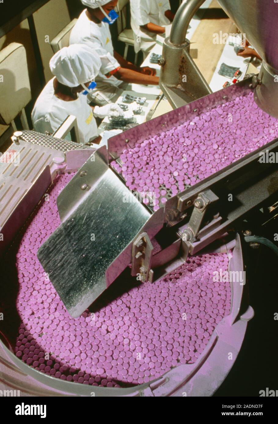 Drug packaging. View of a feed hopper of a tablet packaging machine ...