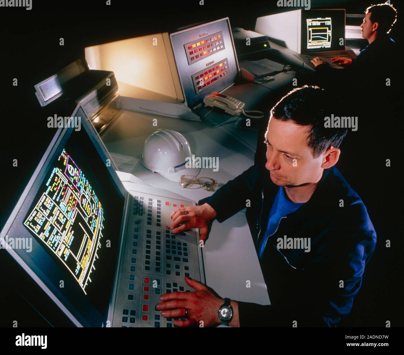 MODEL RELEASED: Control room at a drug factory. View of operators in ...