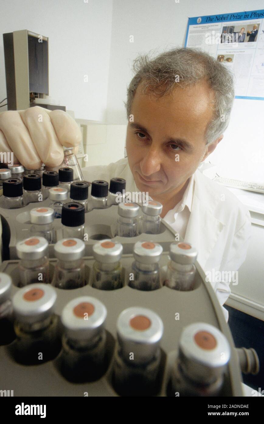 Drug testing. Researcher selecting a sample for gas chromatography ...