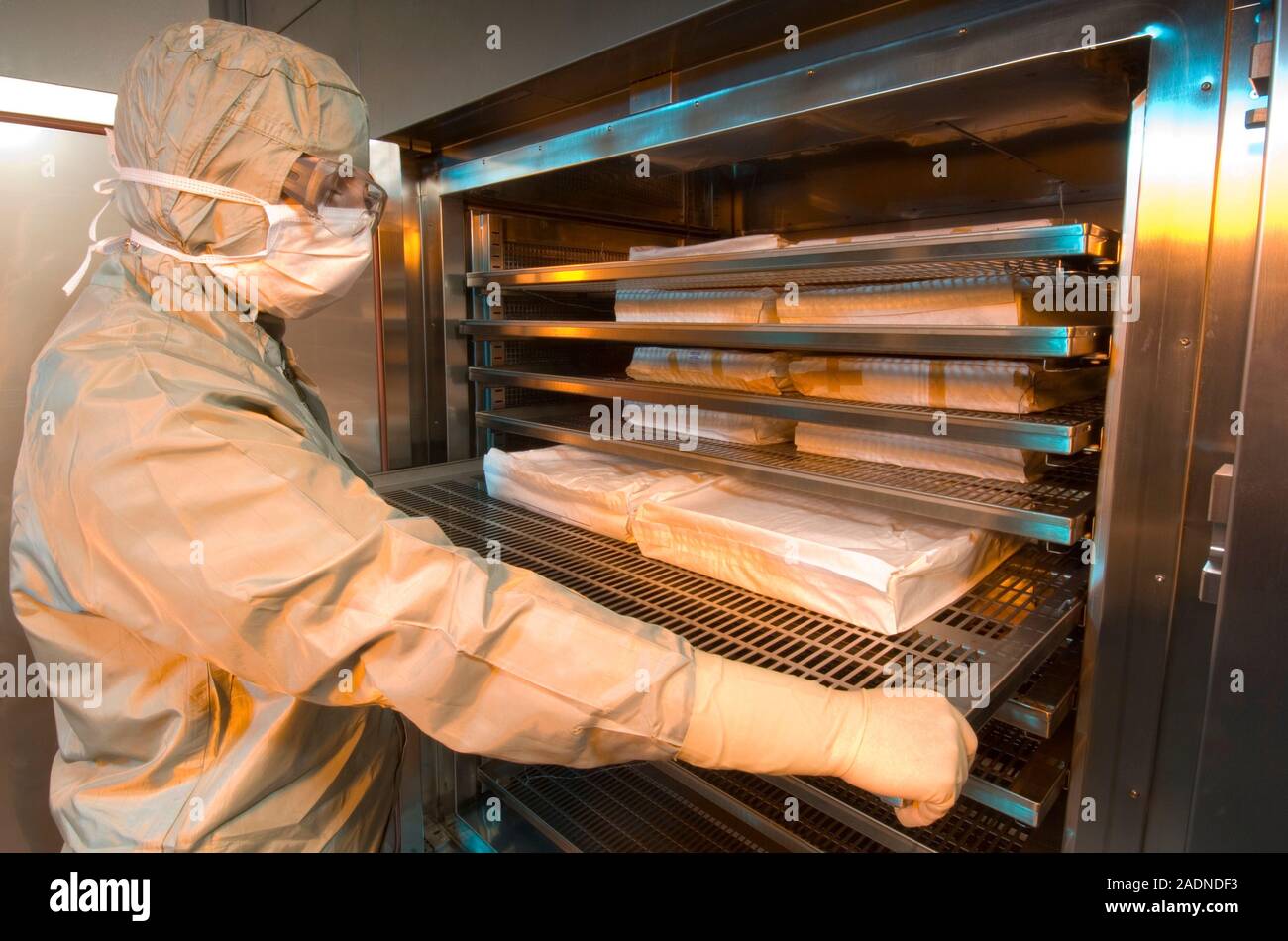 Medical clean room. Clean room worker in full protective clothing ...