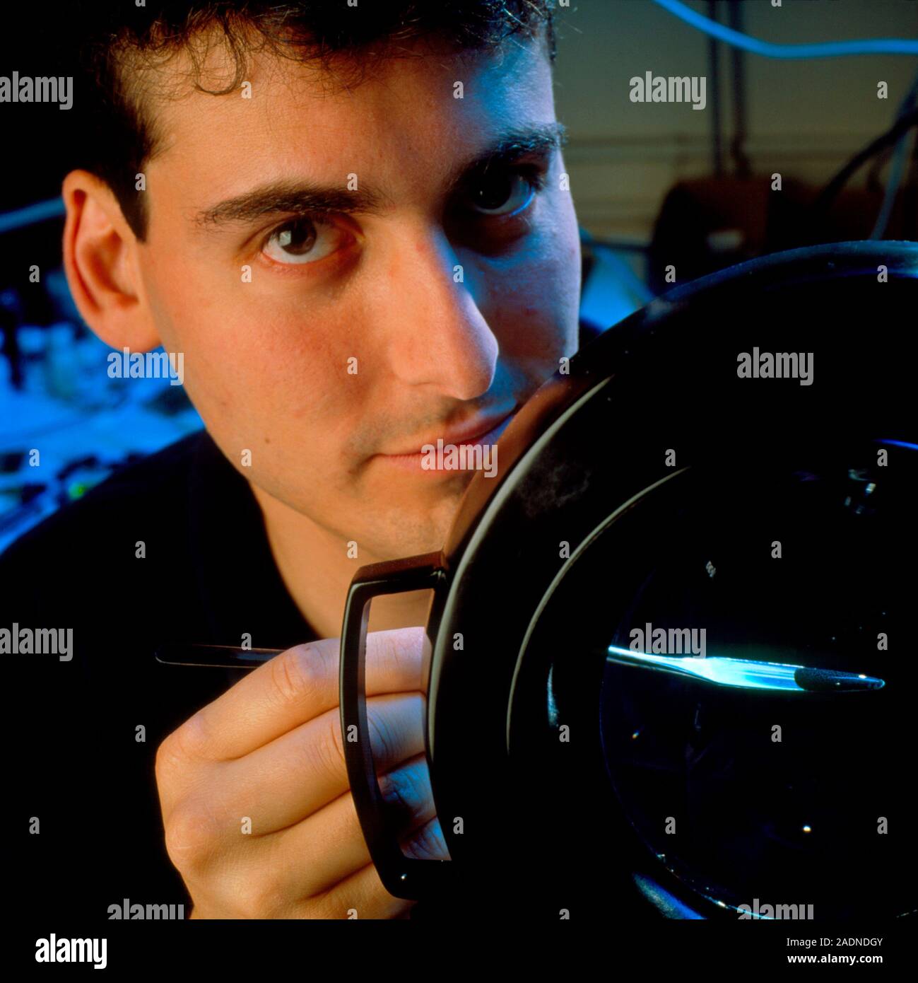 Electronic ink. Dr Joseph Jacobson holding micro- capsules from ...