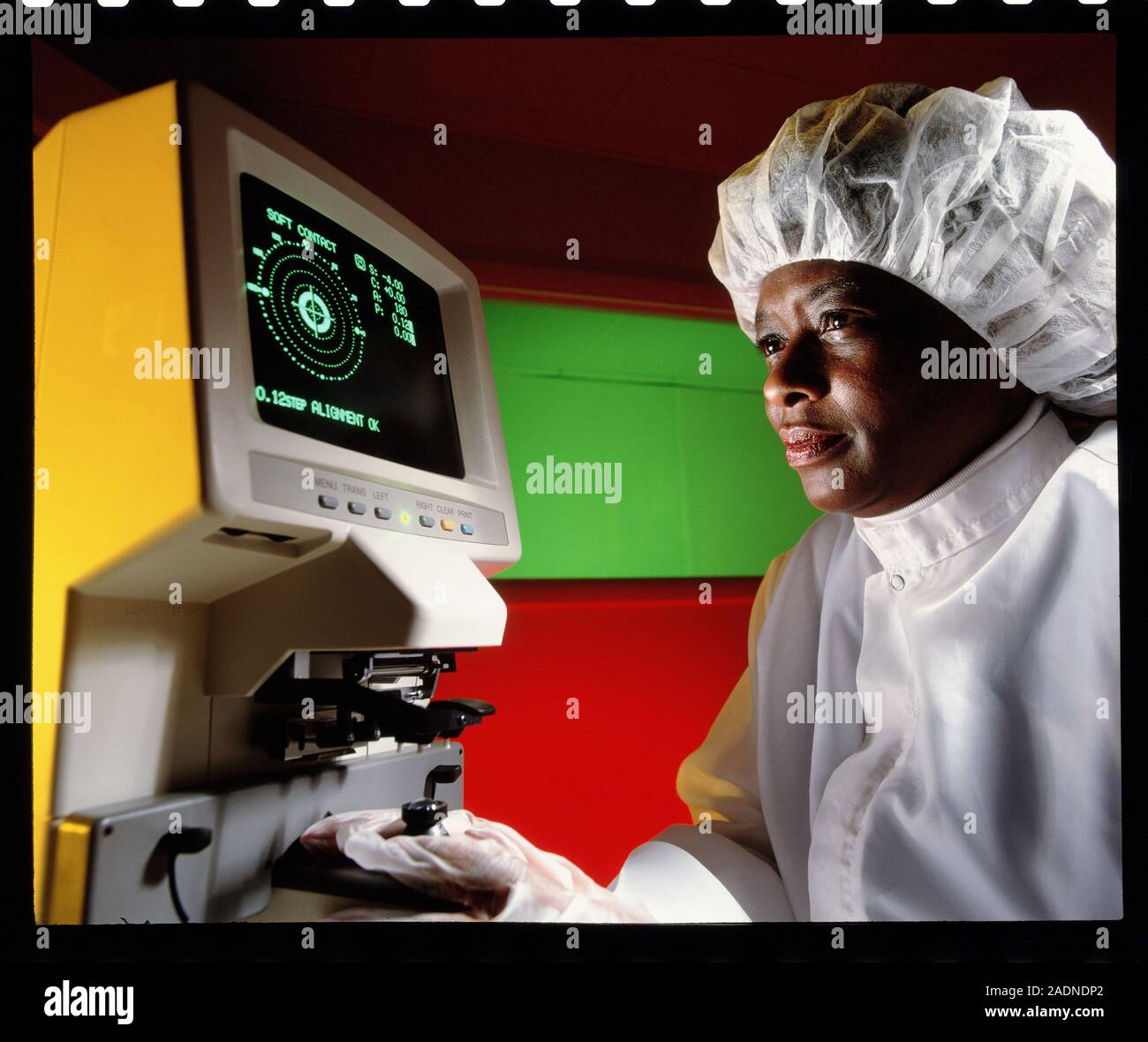 Contact lens testing. Technician electronically measuring the power of ...