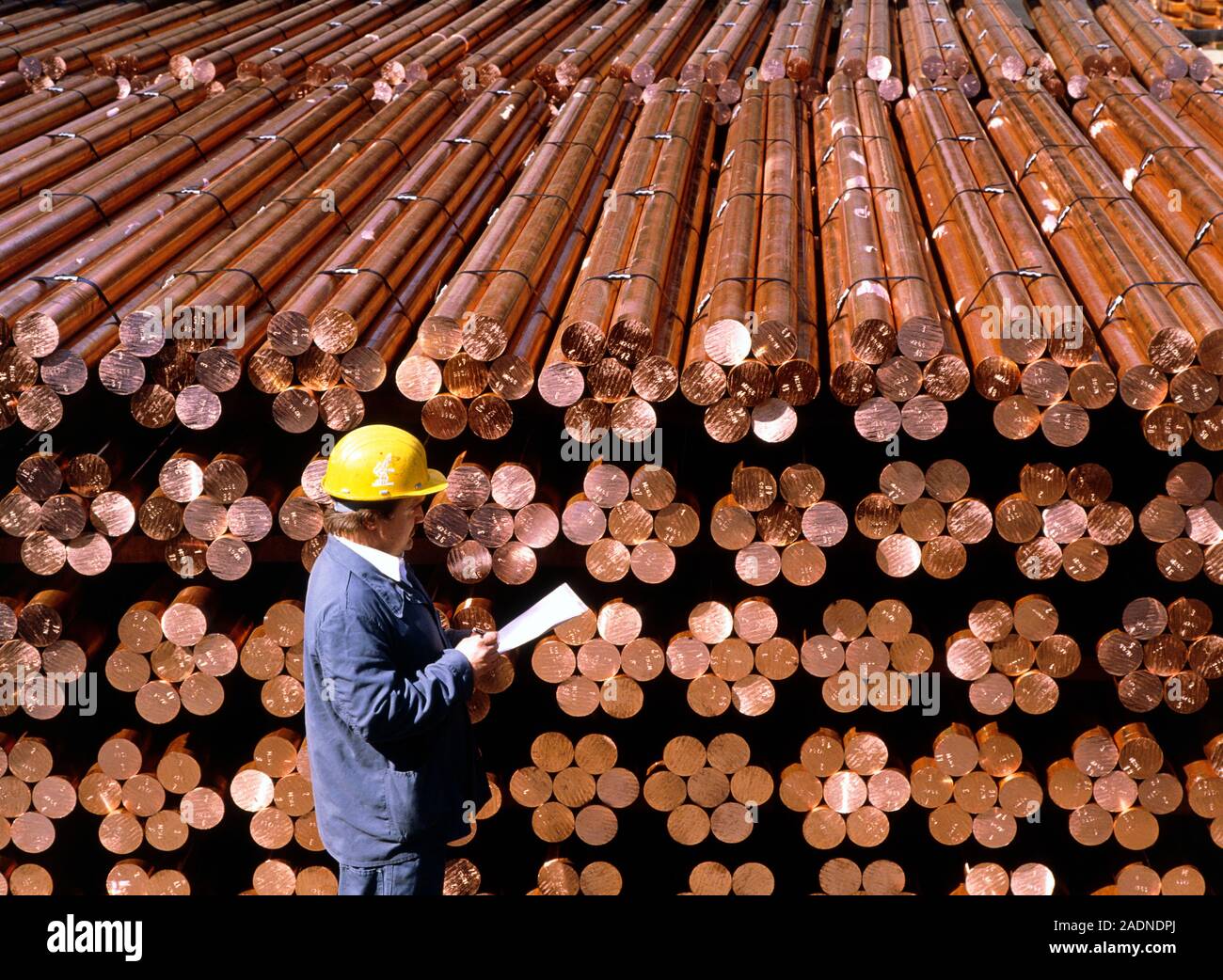 Copper bars. Technician inspecting manufactured bars of copper. Copper ...