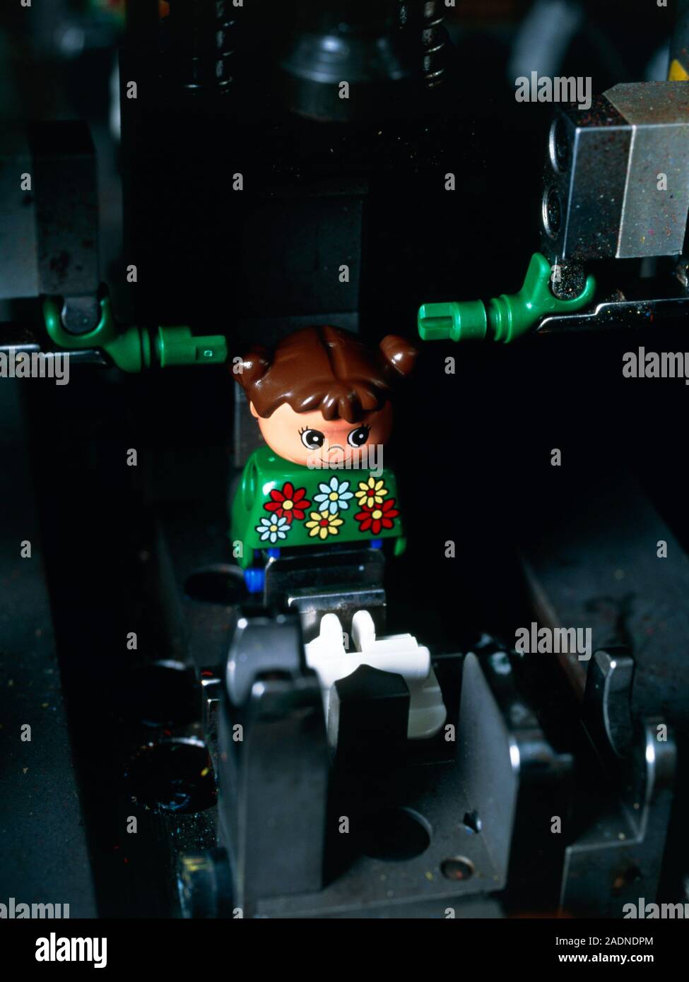 Toy manufacture (image 2 of 2). Toy doll being put together inside a ...