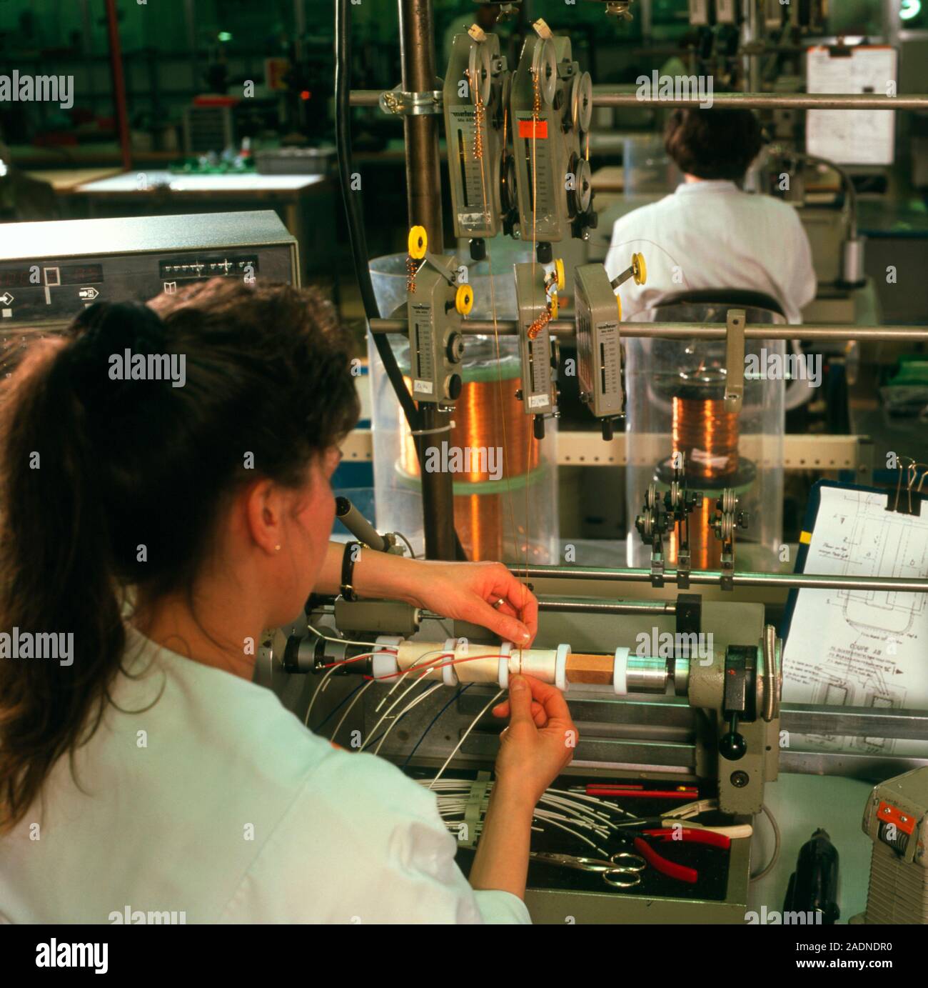 Electrical bobbin manufacture. Factory workers producing electrical ...