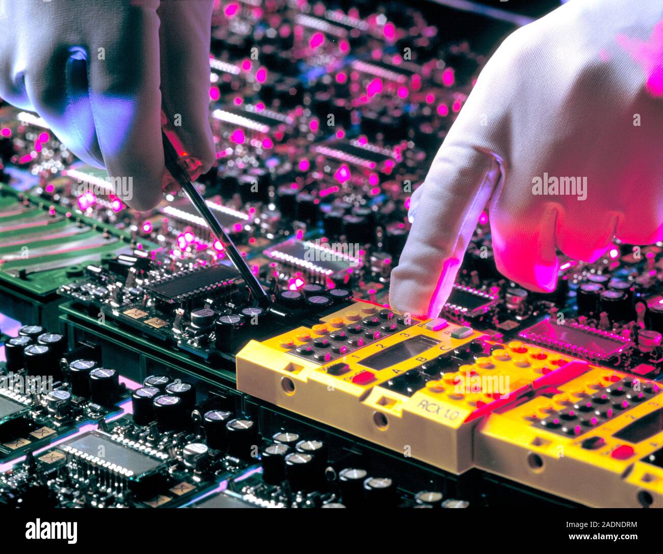 Programmable Lego manufacture. Hands of a technician assembling Lego ...