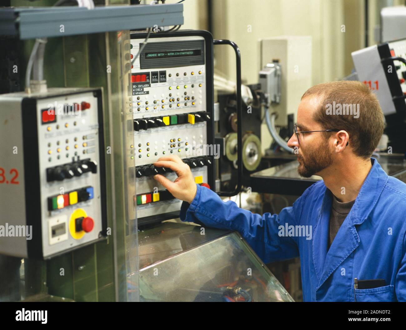 Automated factory machinery. Foreman at the controls of an automated ...