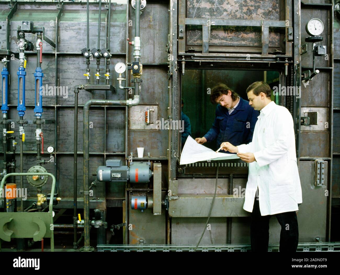Assembling an industrial furnace. Mechanical engineer discussing a ...