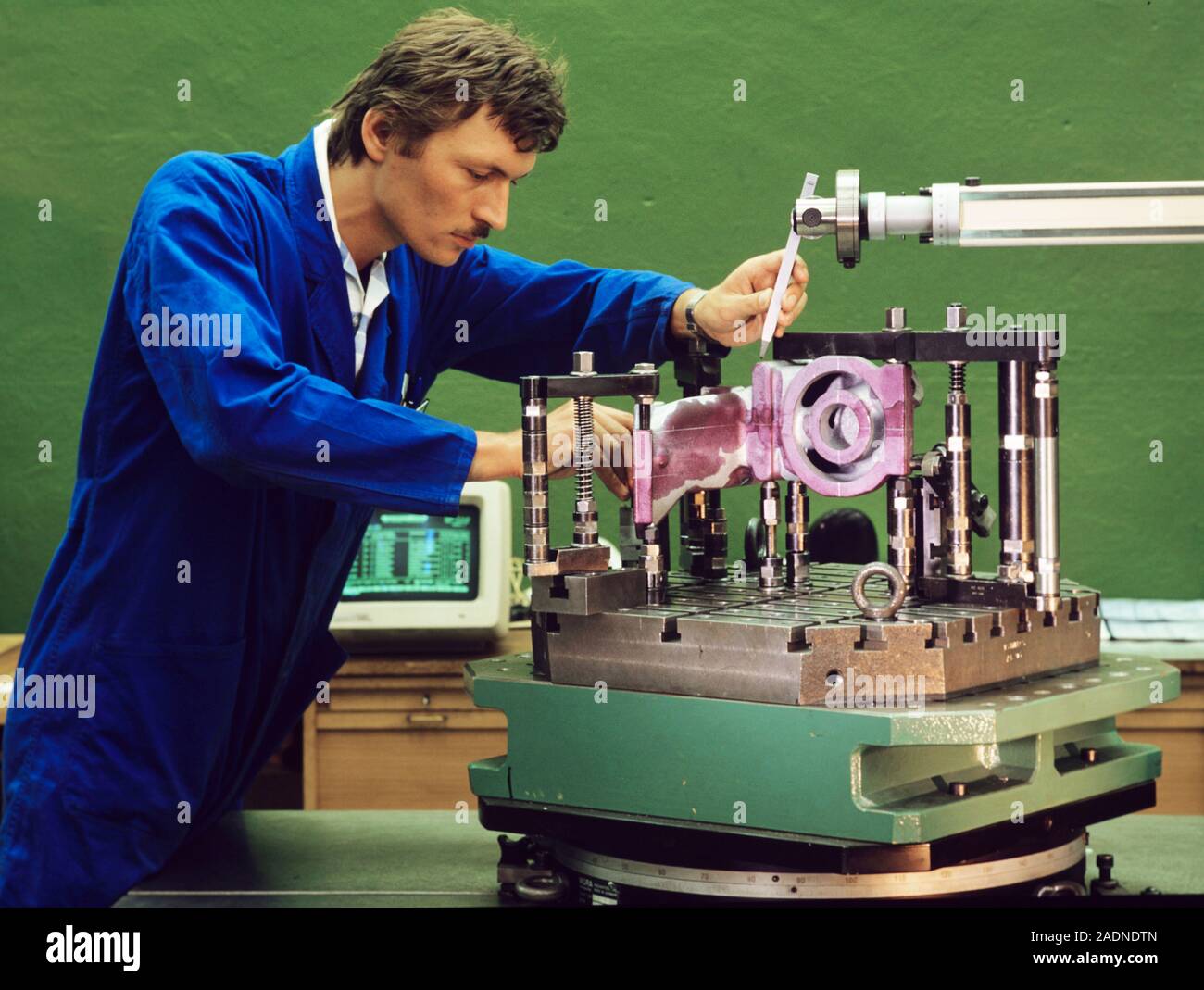 Mechanical engineering. Technician performing a quality control test on ...